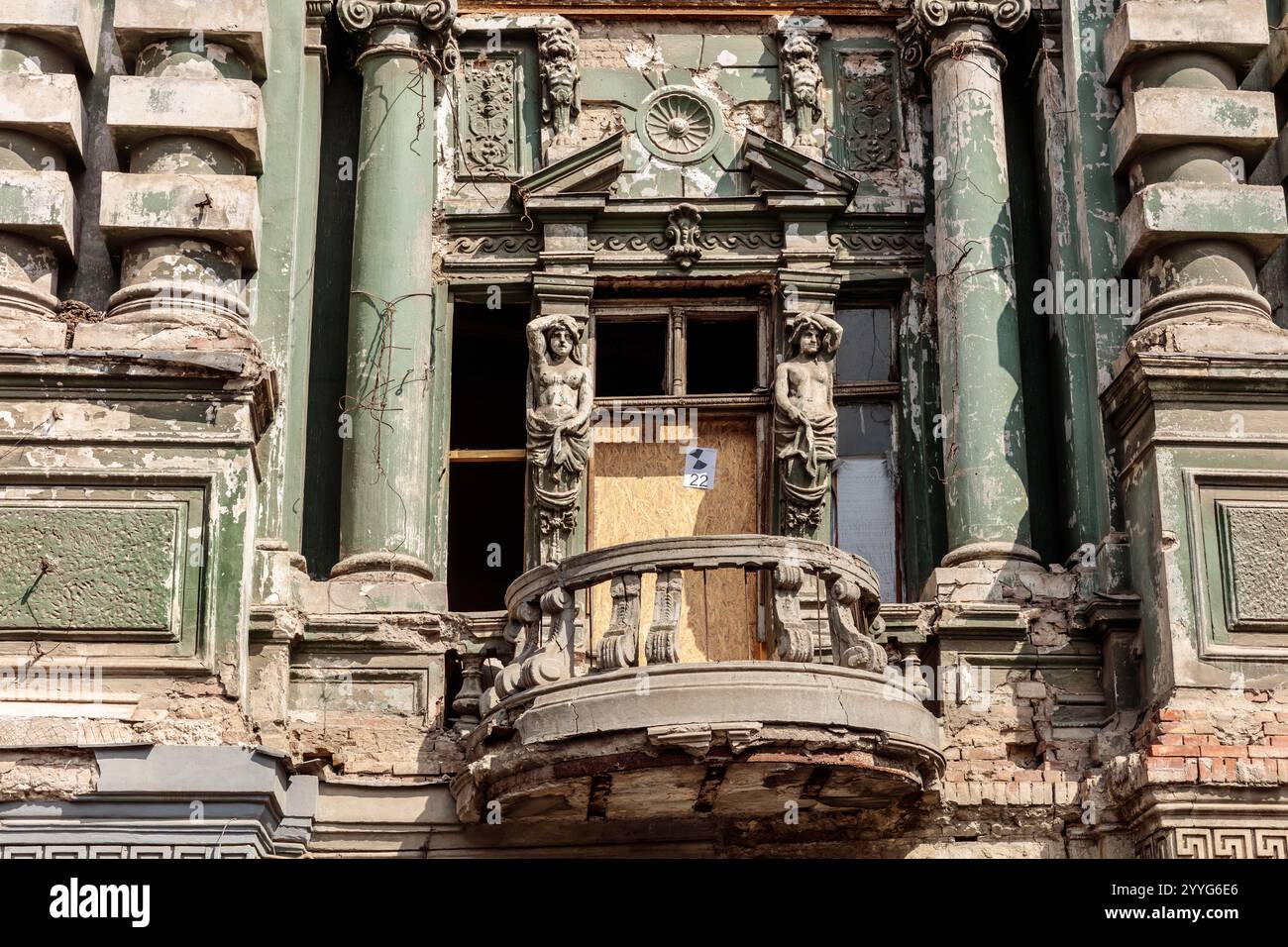 The balcony on the building is empty and the door is boarded up. The ...