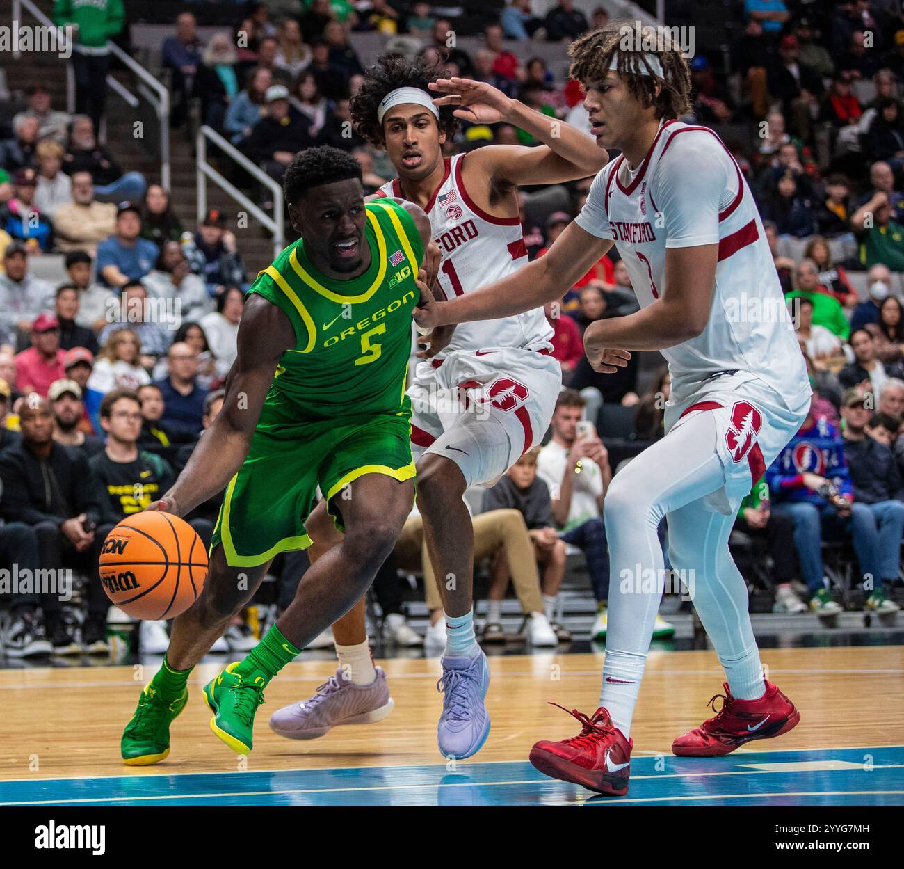 December 21 2024 San Jose, CA U.S.A. Oregon guard TJ Bamba (5)drives to ...