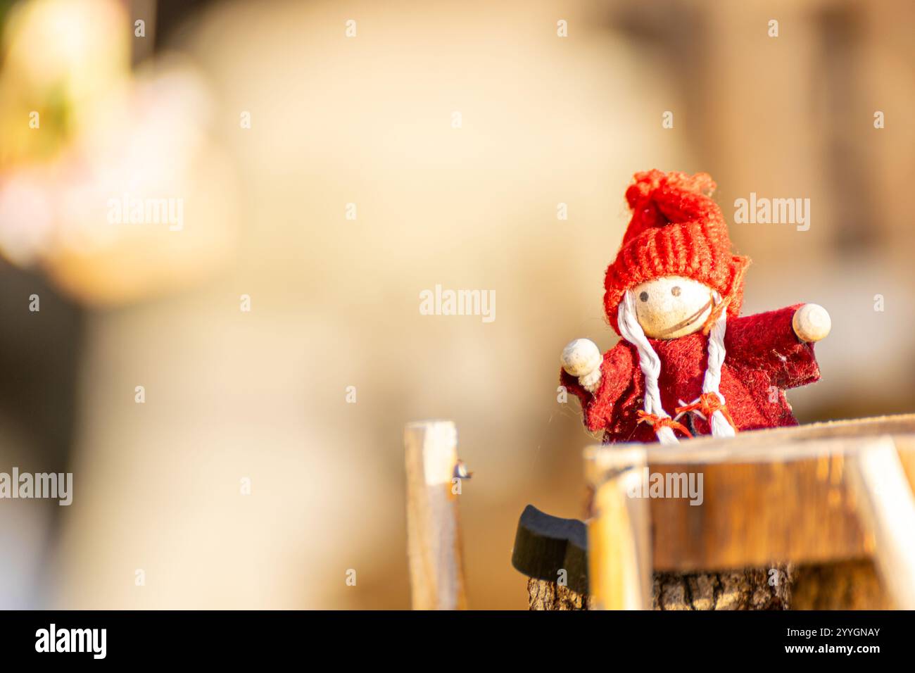 a red dressed elf sitting in a fairy village of homemade handmade ...
