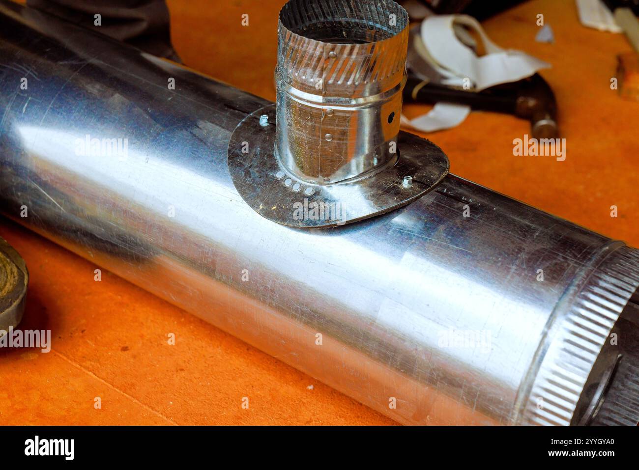 HVAC heating duct metal exhaust piece on workshop bench, repair work in ...