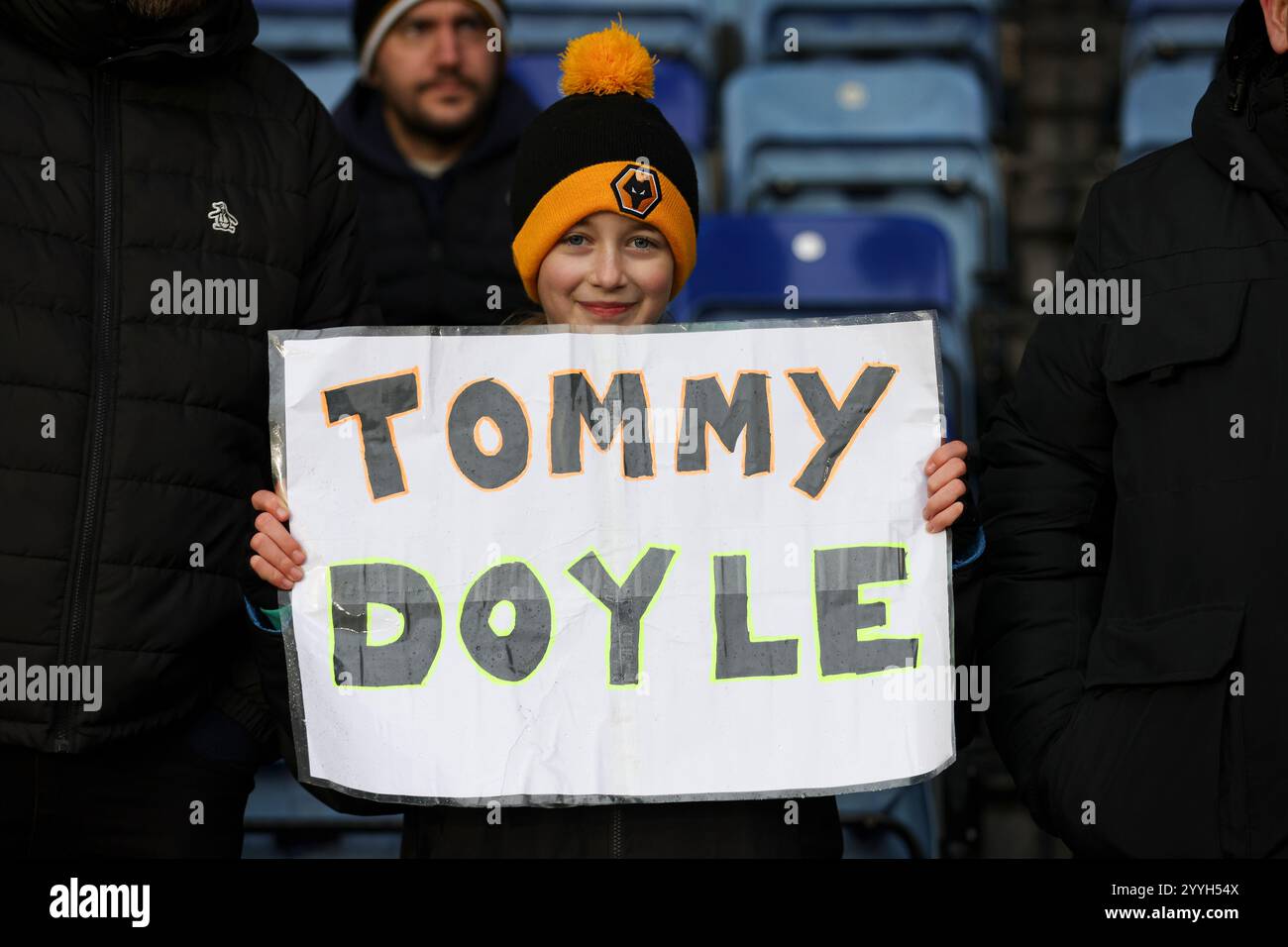 Wolverhampton, UK. 22nd Dec, 2024. A young Wolves supporter holds a s ...