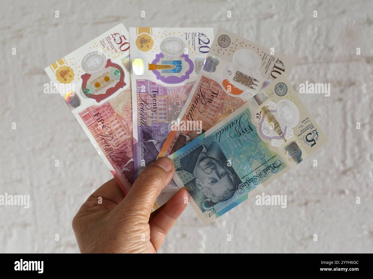 Woman Hand Holding British Currency Pound Banknotes with Wall ...