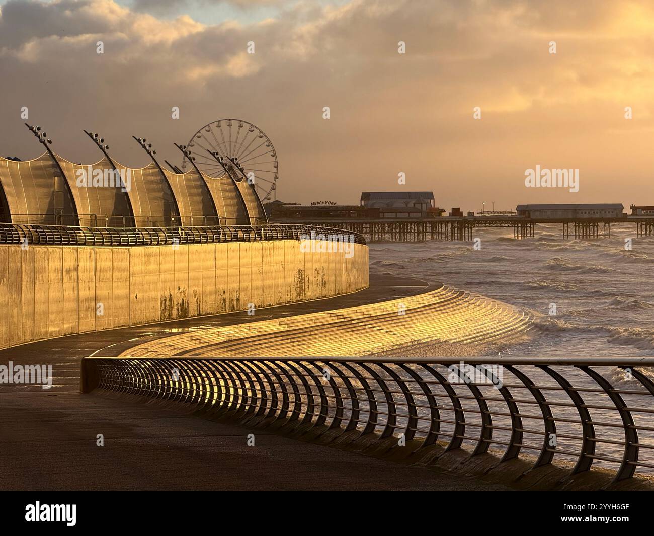Blackpool Central Pier from promenade lit by winter evening sunlight ...