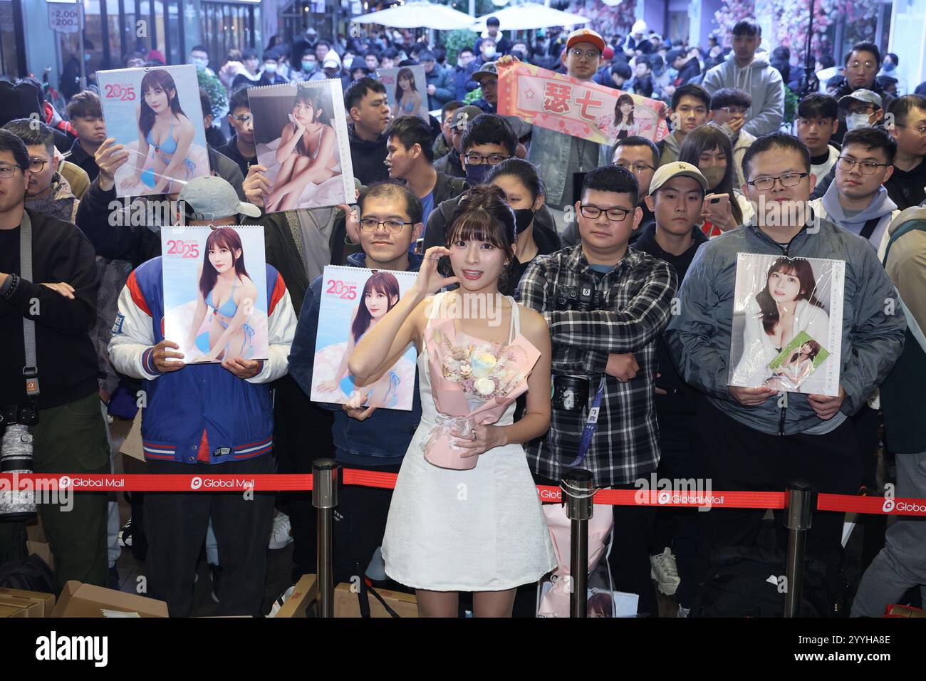 Yiwen Lin, a member of the professional baseball cheerleading squad, holds a monthly calendar ...