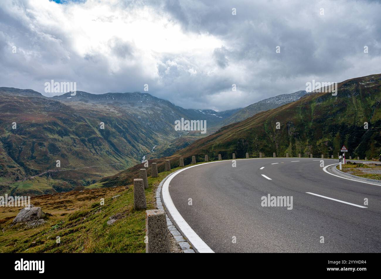 Senic view of the Swiss Alps in the background and a curving road in ...