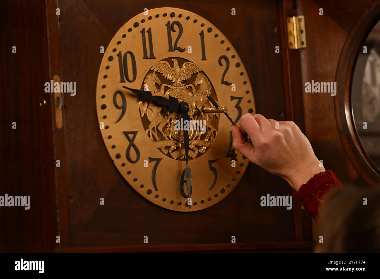 Bethany Gill winds a clock in the Pennsylvania Supreme Court chamber ...