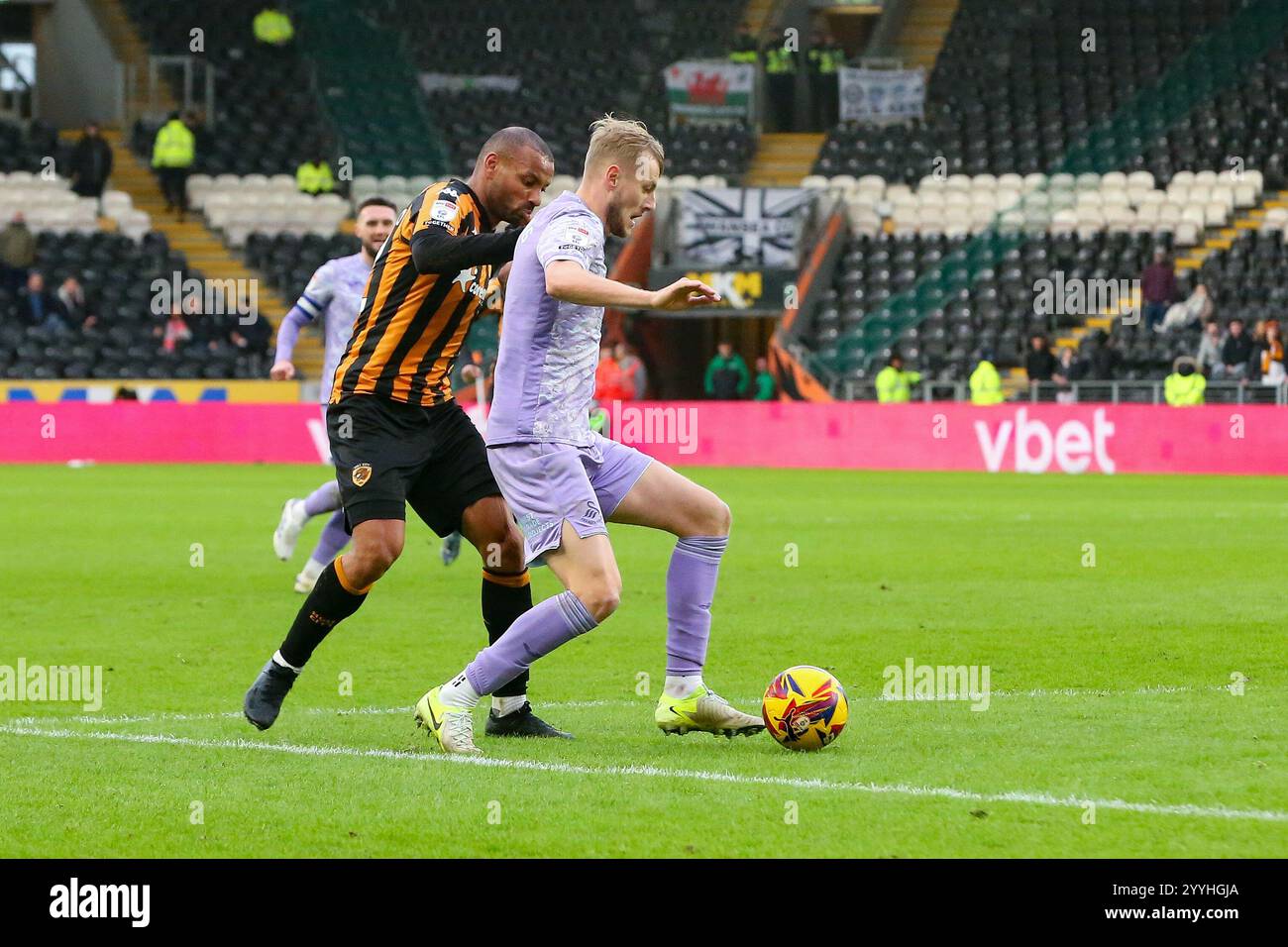 MKM Stadium, Hull, England - 21st December 2024 Harry Darling (right) of Swansea City shields ...