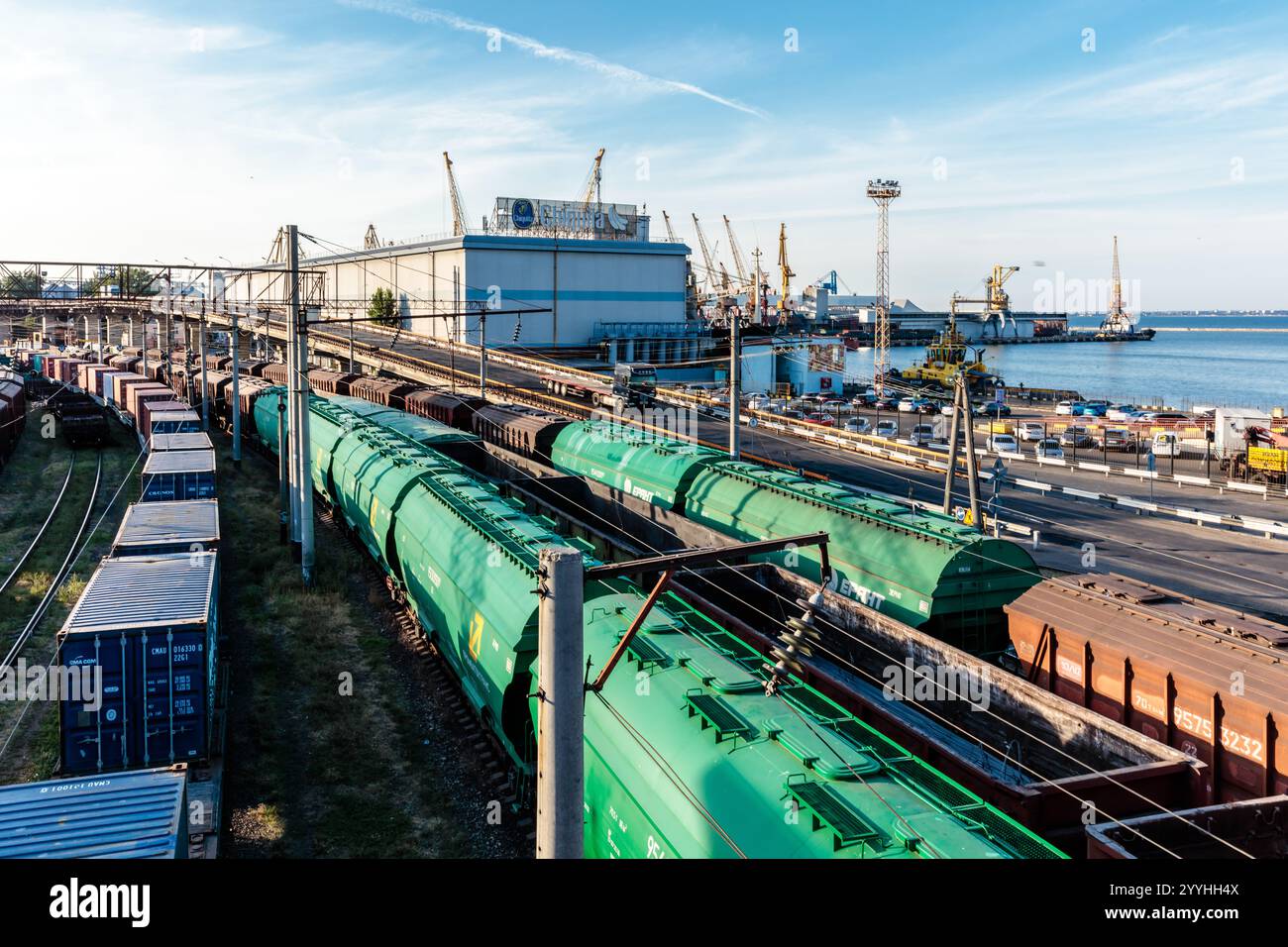 A train is pulling into a station with a large building in the ...