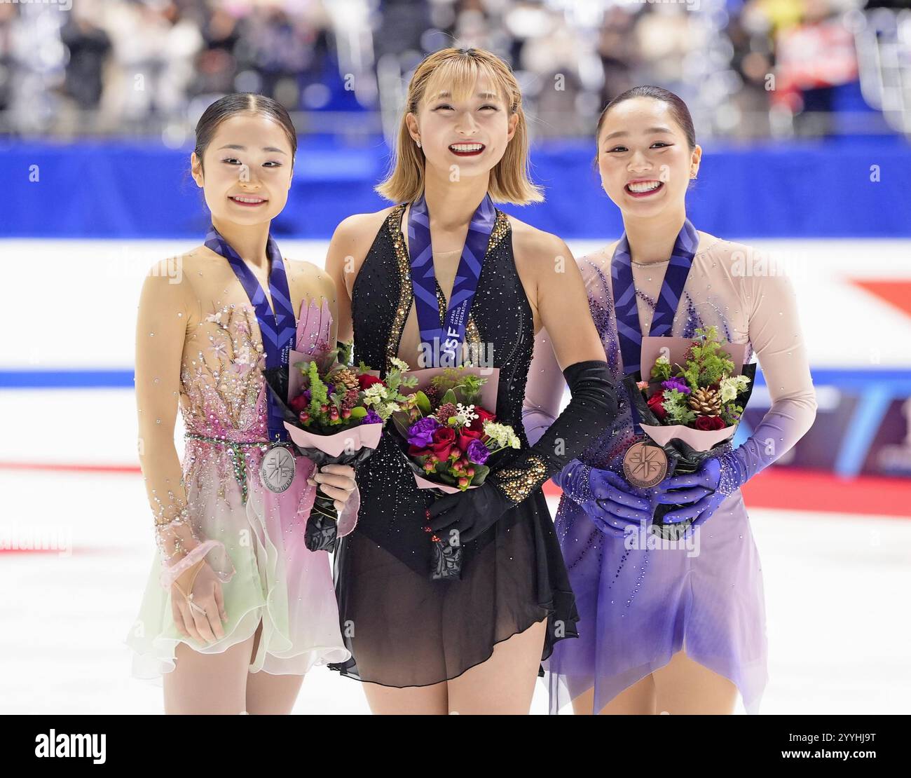 Kaori Sakamoto (C) poses after winning gold in the women's event at the ...
