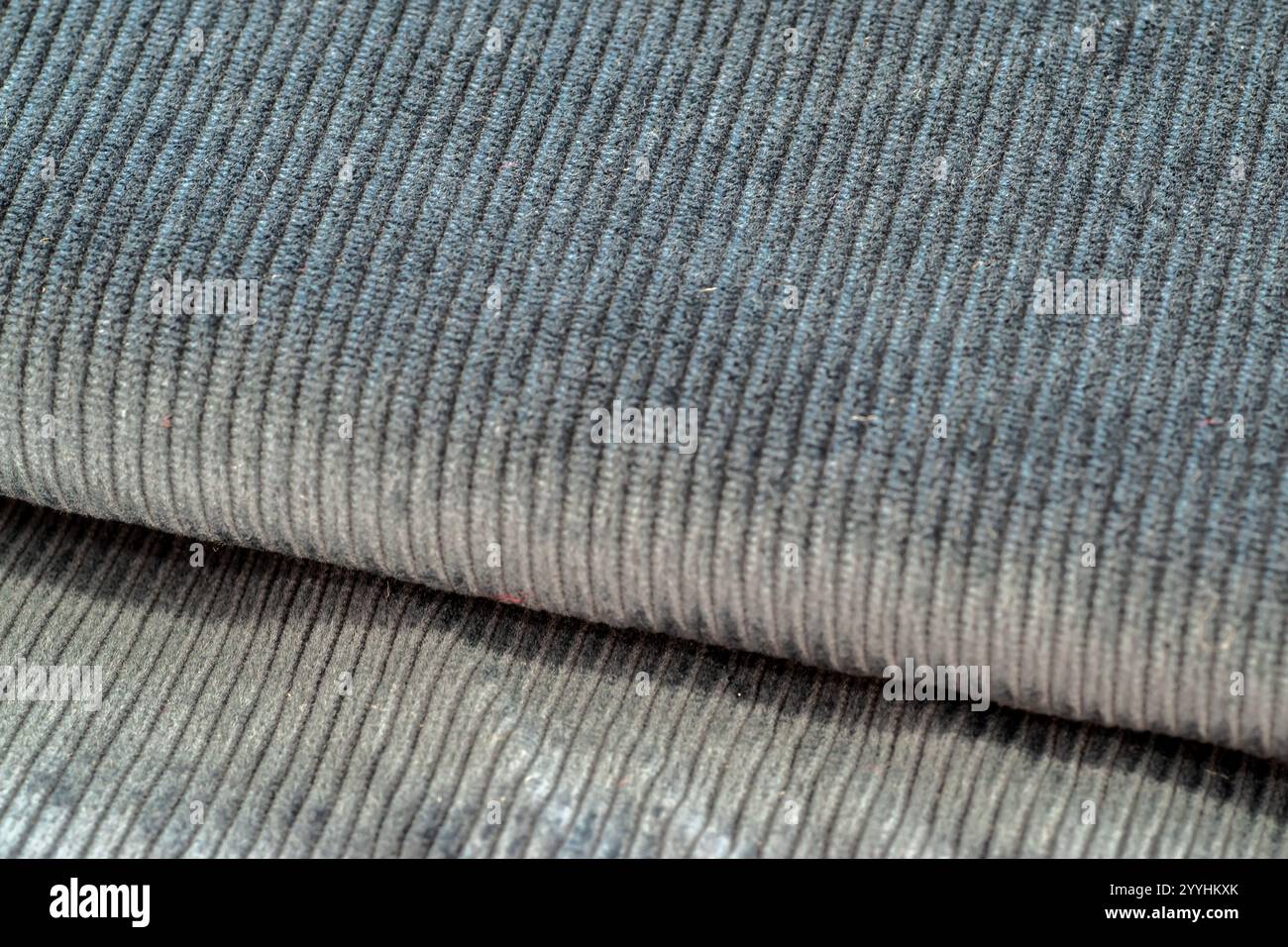 Grey textured corduroy fabric patterns closeup as textile background ...