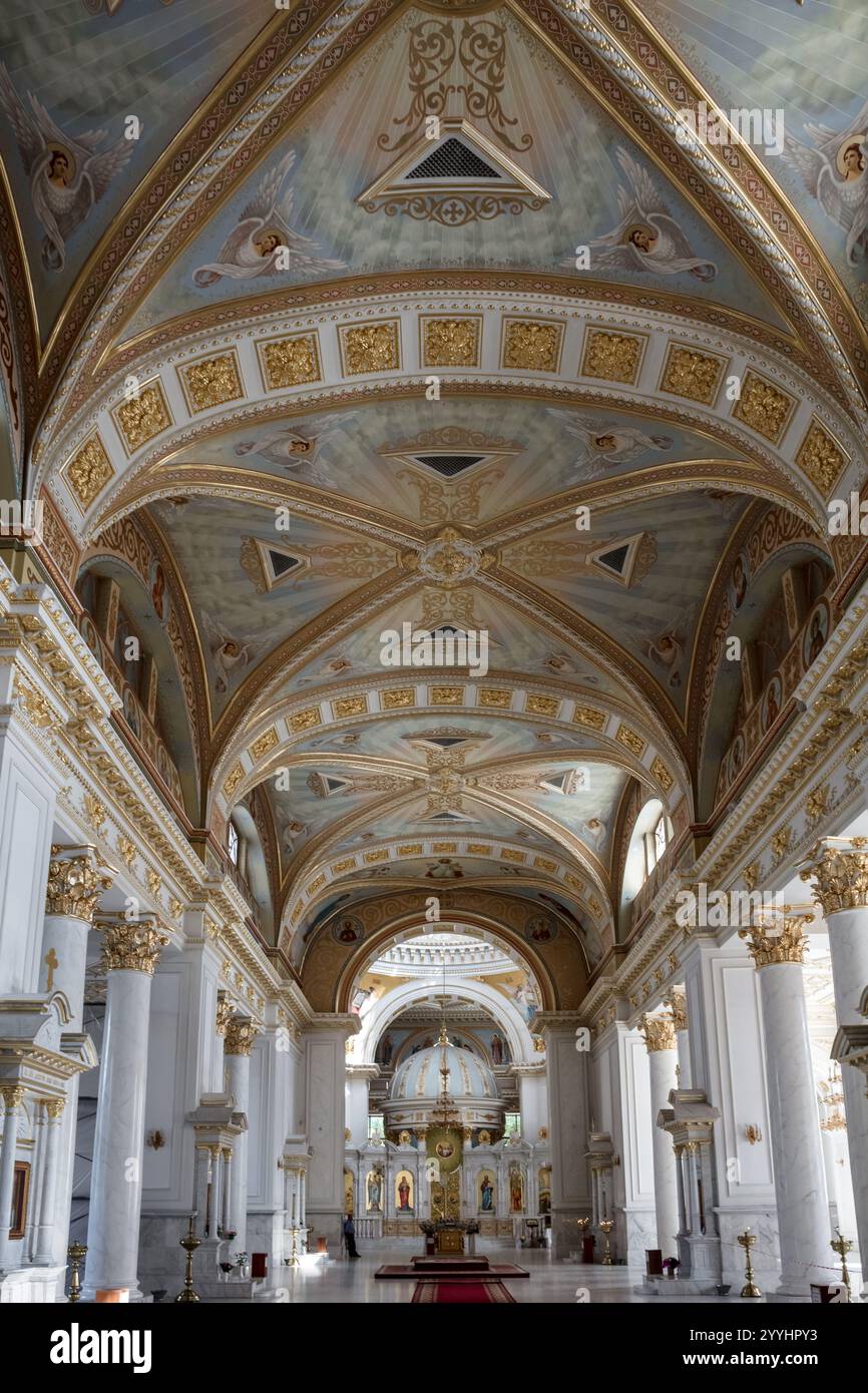 The inside of a large church with a high ceiling and gold accents. The ...