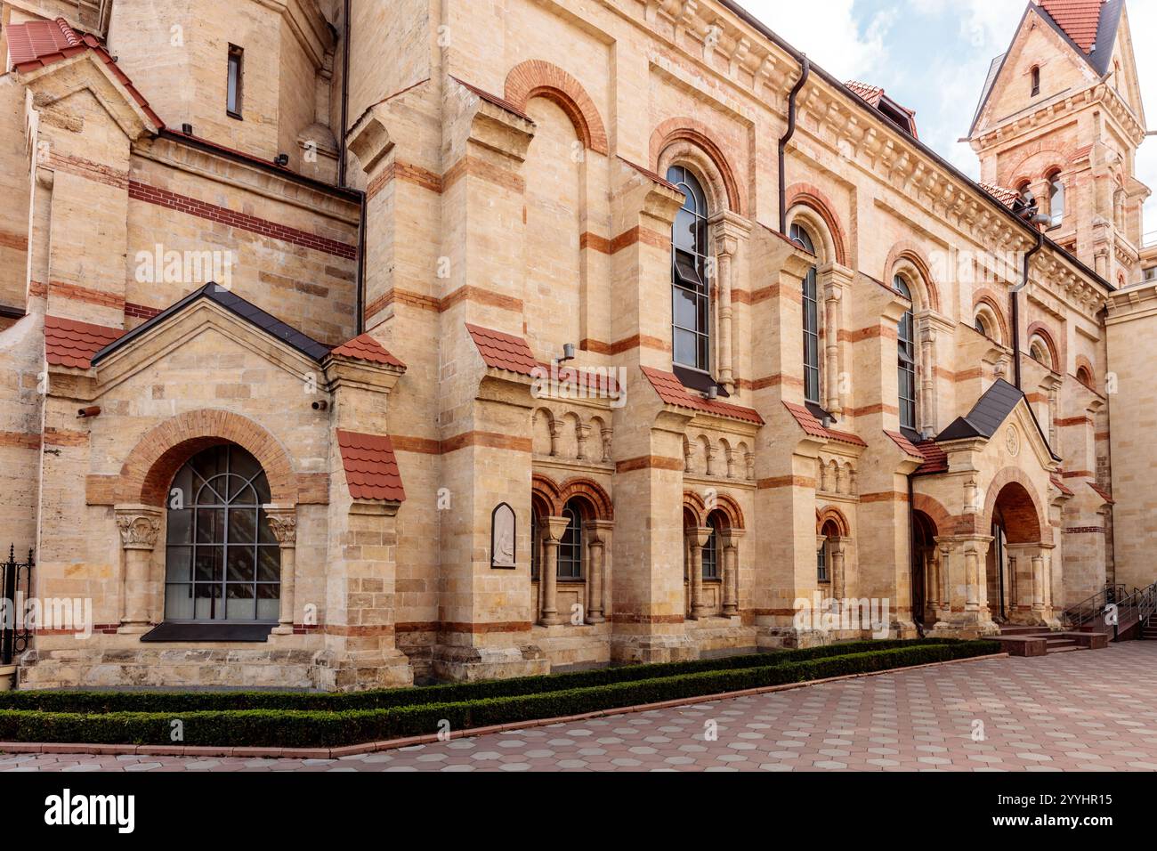 A large brick building with a steeple and a clock tower. The building ...