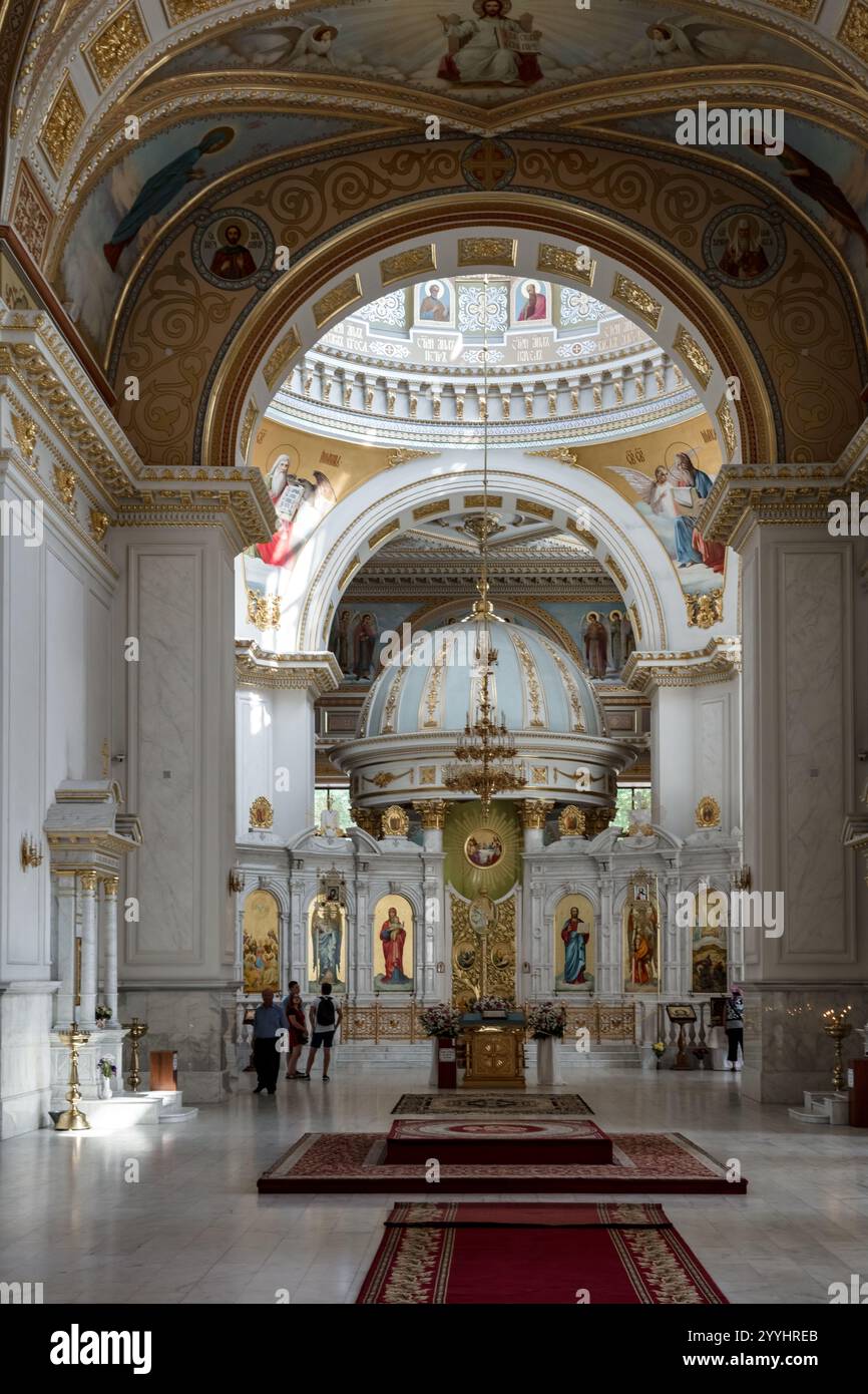 A large church with a gold dome and gold trim. The inside is very white ...