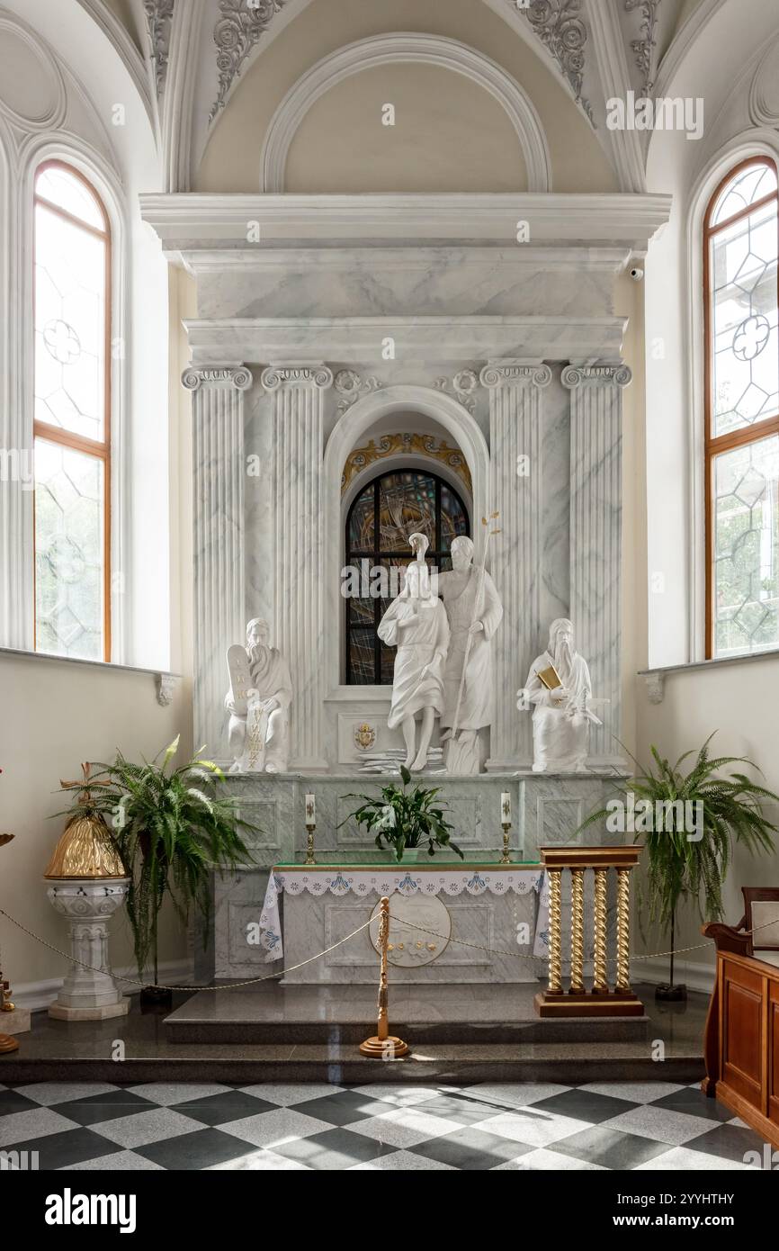 A white church with a statue of Jesus Christ in the middle. The statue ...