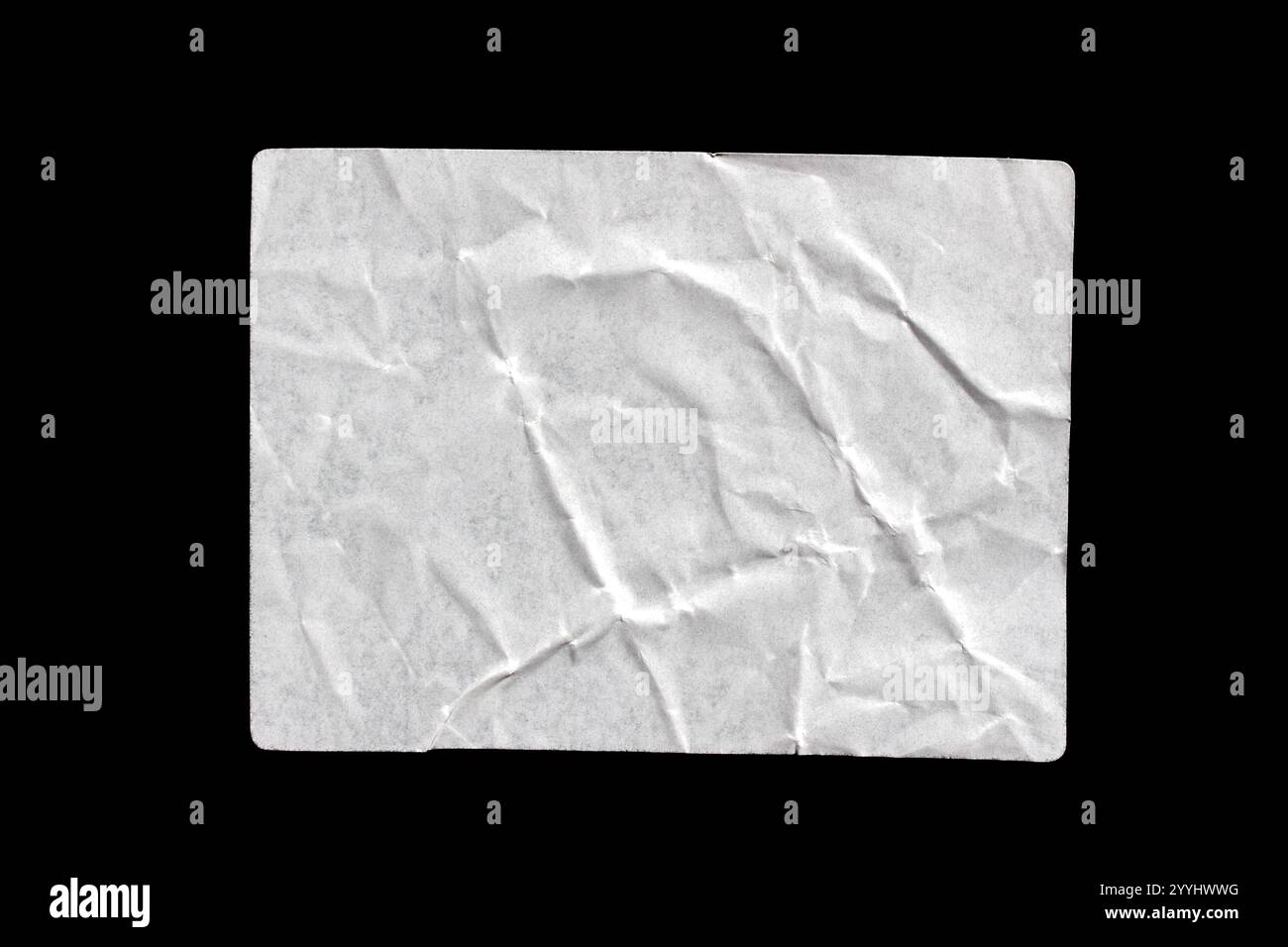 White adhesive glued creased paper sticker label isolated on black ...