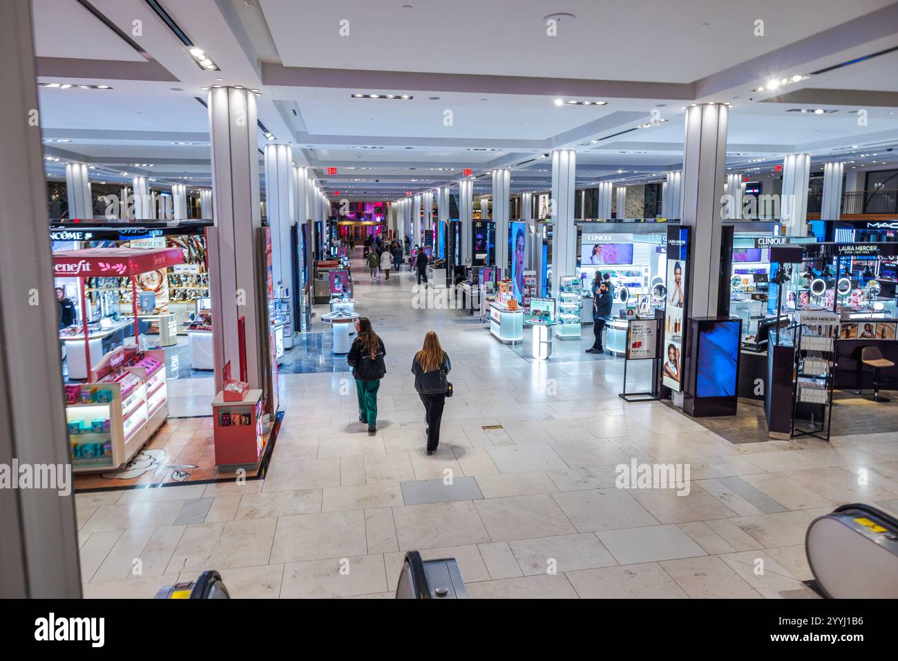 Brightly lit Macy's cosmetics section with luxury beauty brand counters ...
