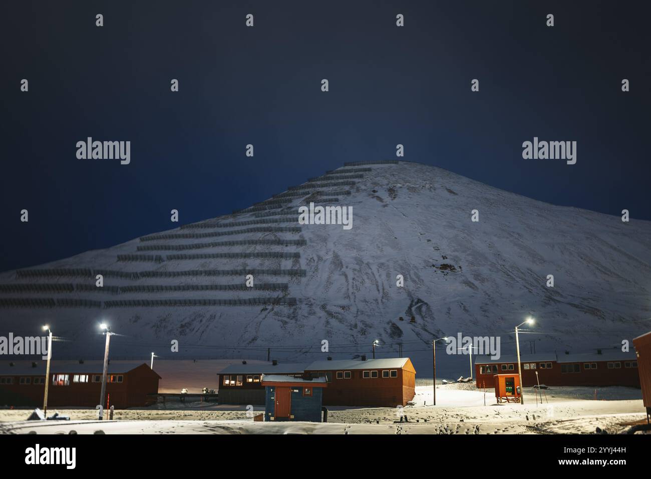 Snowy mountain with avalanche barriers above Longyearbyen, Svalbard ...