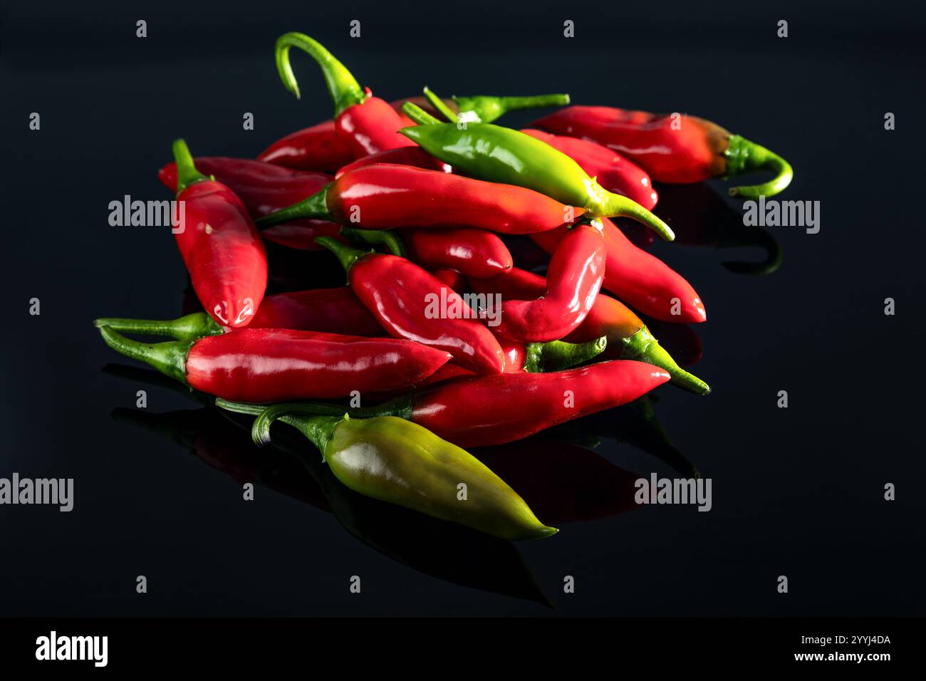 A variety of red and green chili peppers , showcasing their rich colors ...