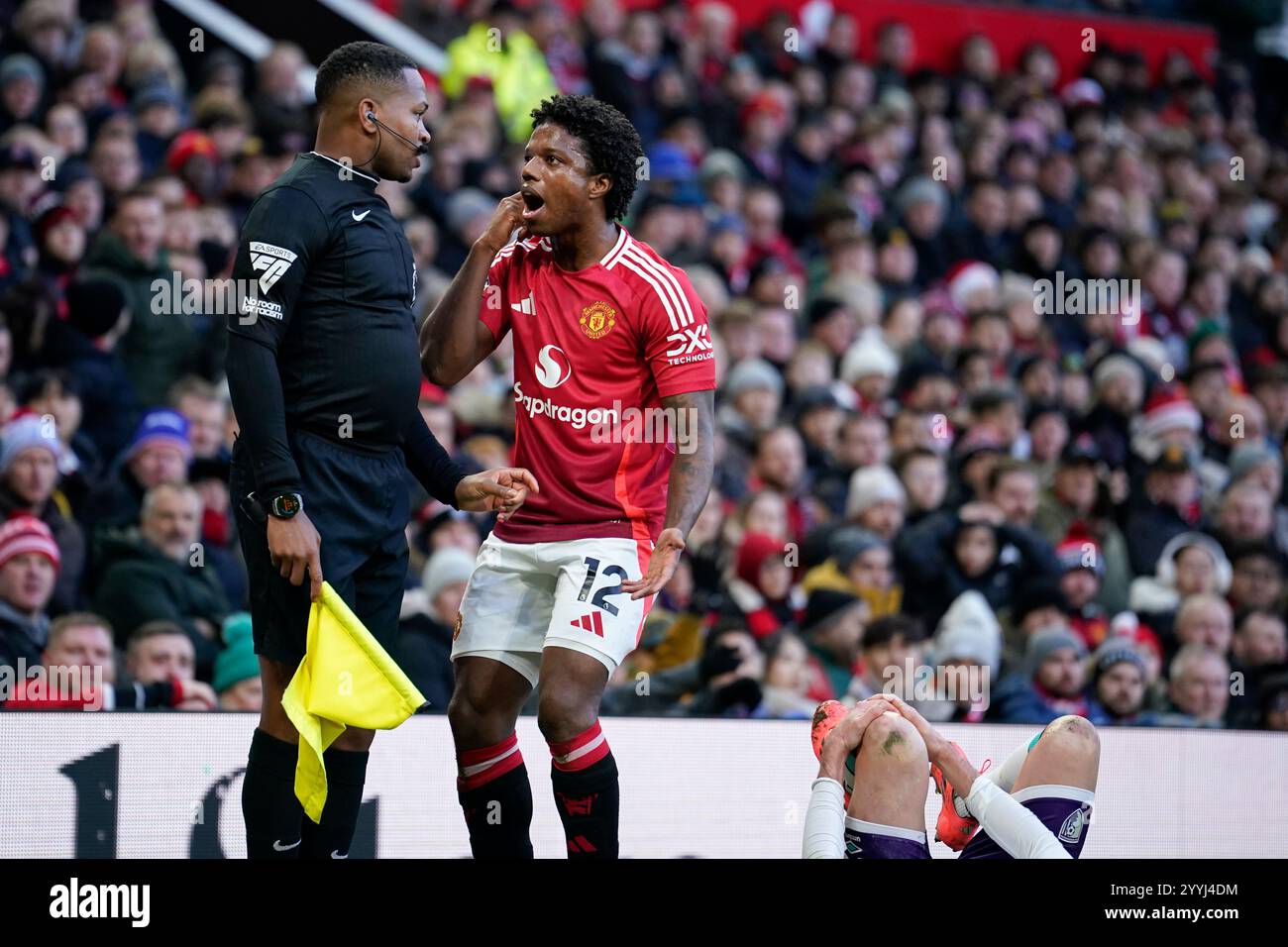 Manchester United's Tyrell Malacia argues with line referee Akil Howson ...