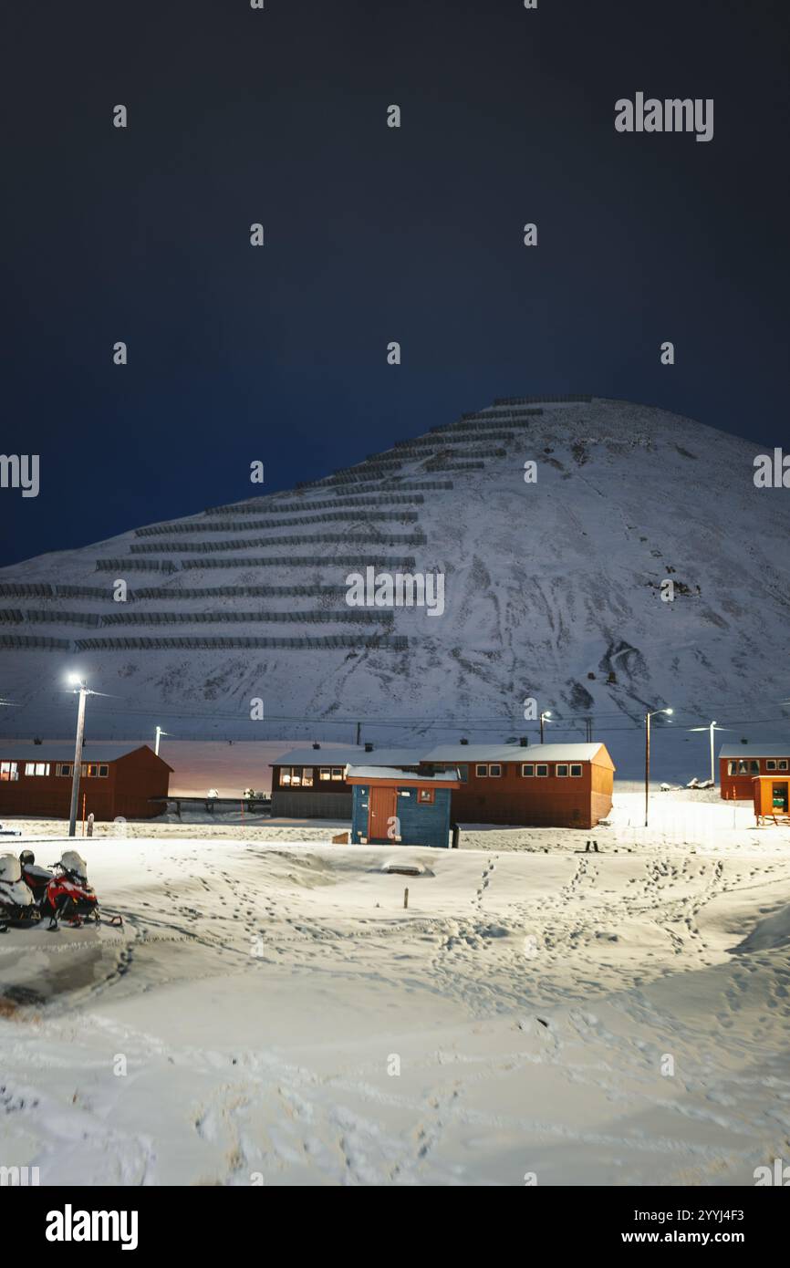 Snowy mountain in Longyearbyen, Svalbard above houses in the polar ...