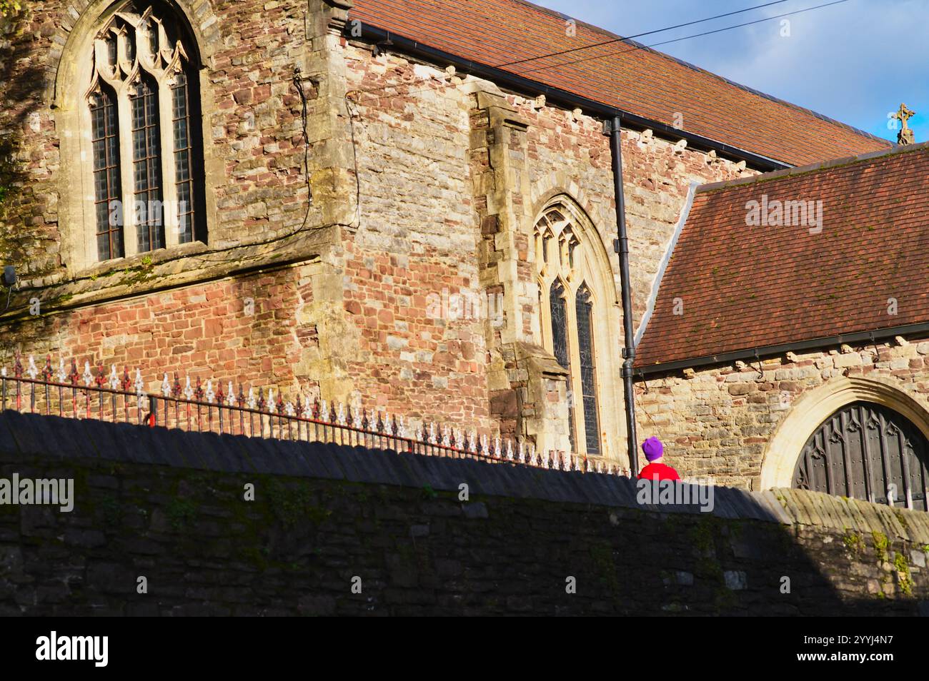 Cleric in red hat walking to church. St Woolos Cathedral, Newport South ...