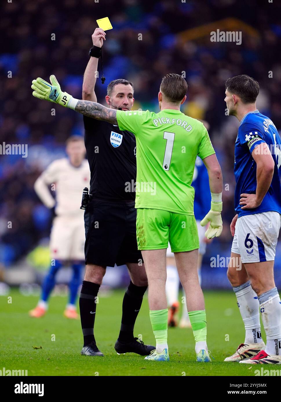 Referee Christopher Kavanagh shows Everton goalkeeper Jordan Pickford a ...