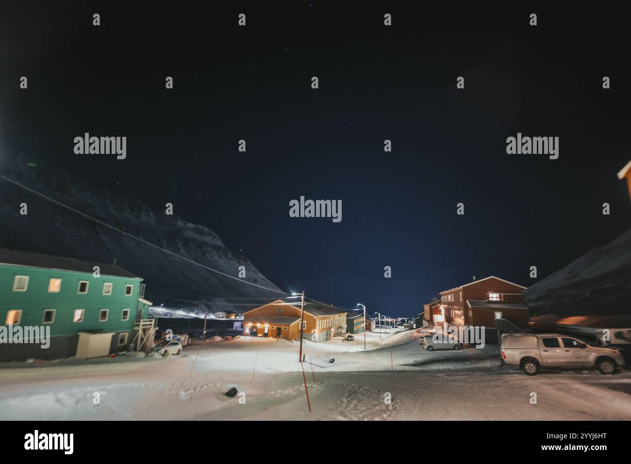 Snowy road through Nybyen in Longyearbyen, Svalbard in the starry polar ...