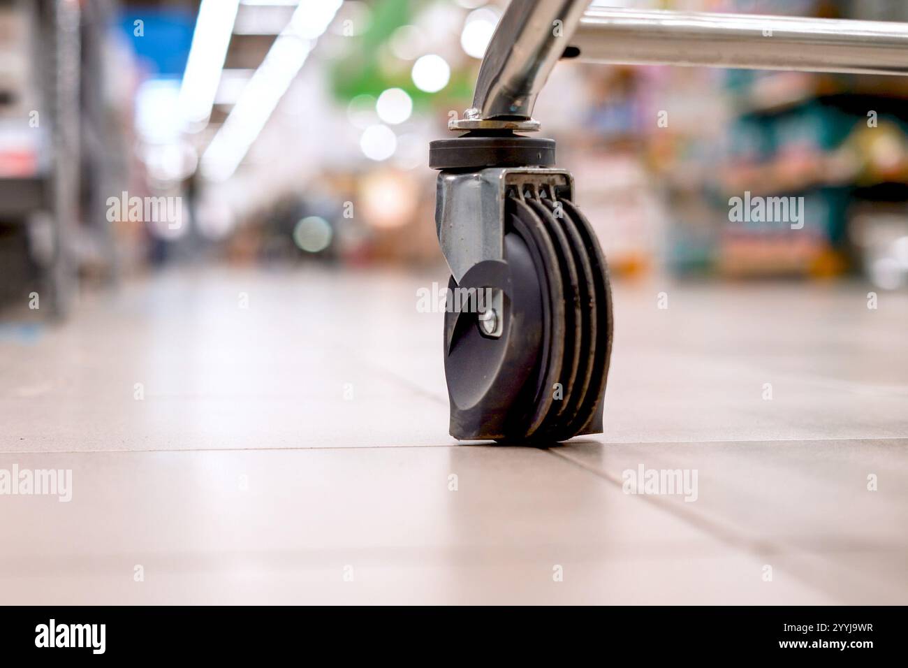 A detailed close-up shot of a shopping cart wheel moving inside a ...