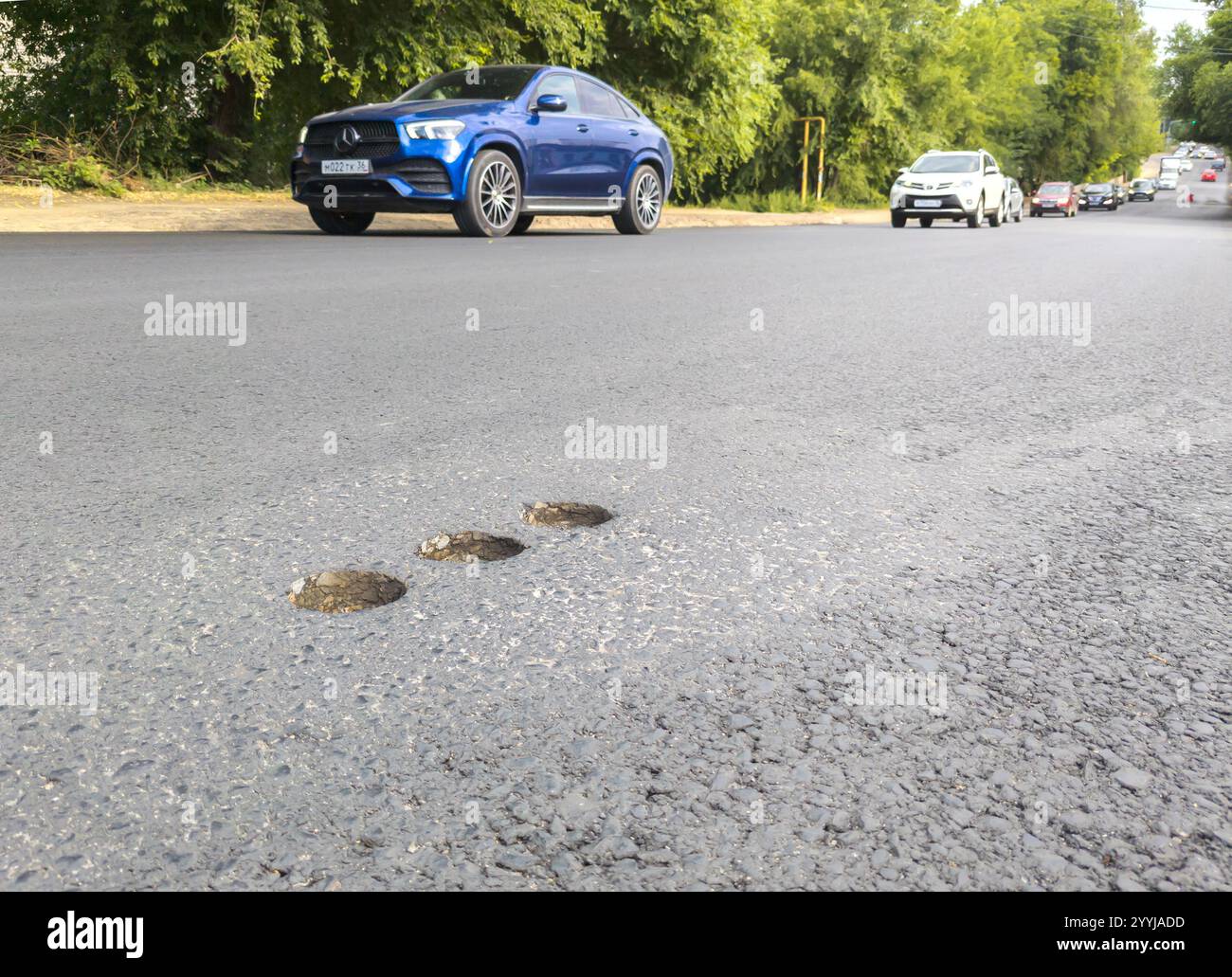 Voronezh, Russia - Juny 03, 2024: A row of holes from asphalt sampling ...