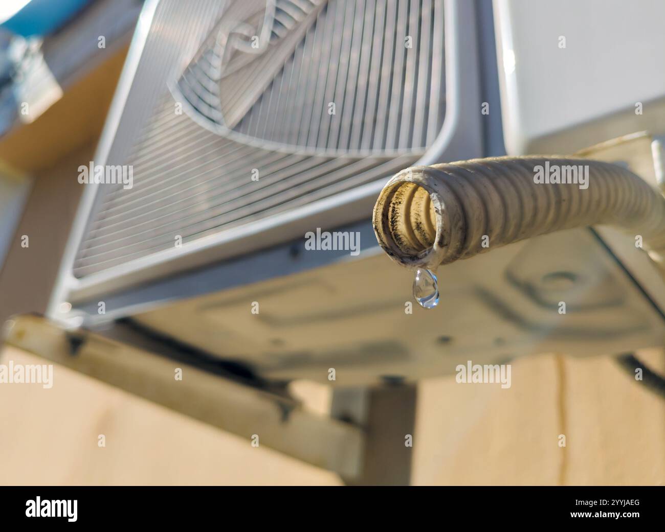 Water dripping from the drain pipe of the outdoor unit of the air ...