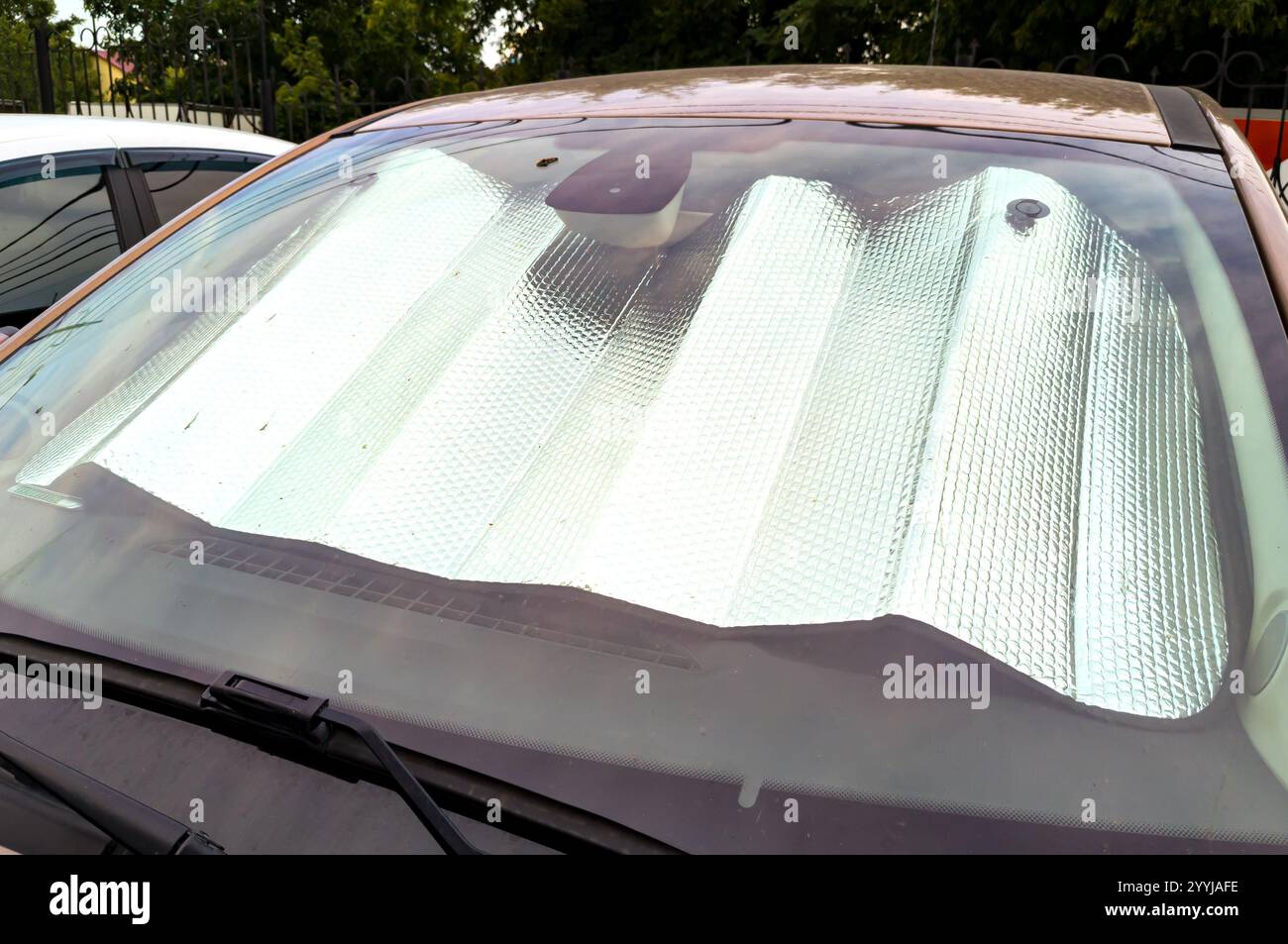 Sun protection screen on the windshield of a car Stock Photo - Alamy