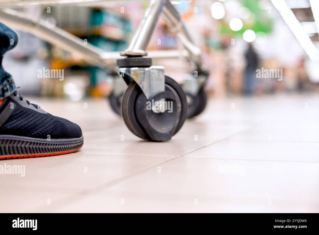 Wheel of a grocery cart in a supermarket Stock Photo - Alamy