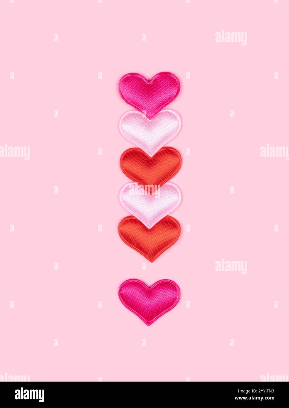 Exclamation mark made of glossy atlas hearts isolated on solid pink ...