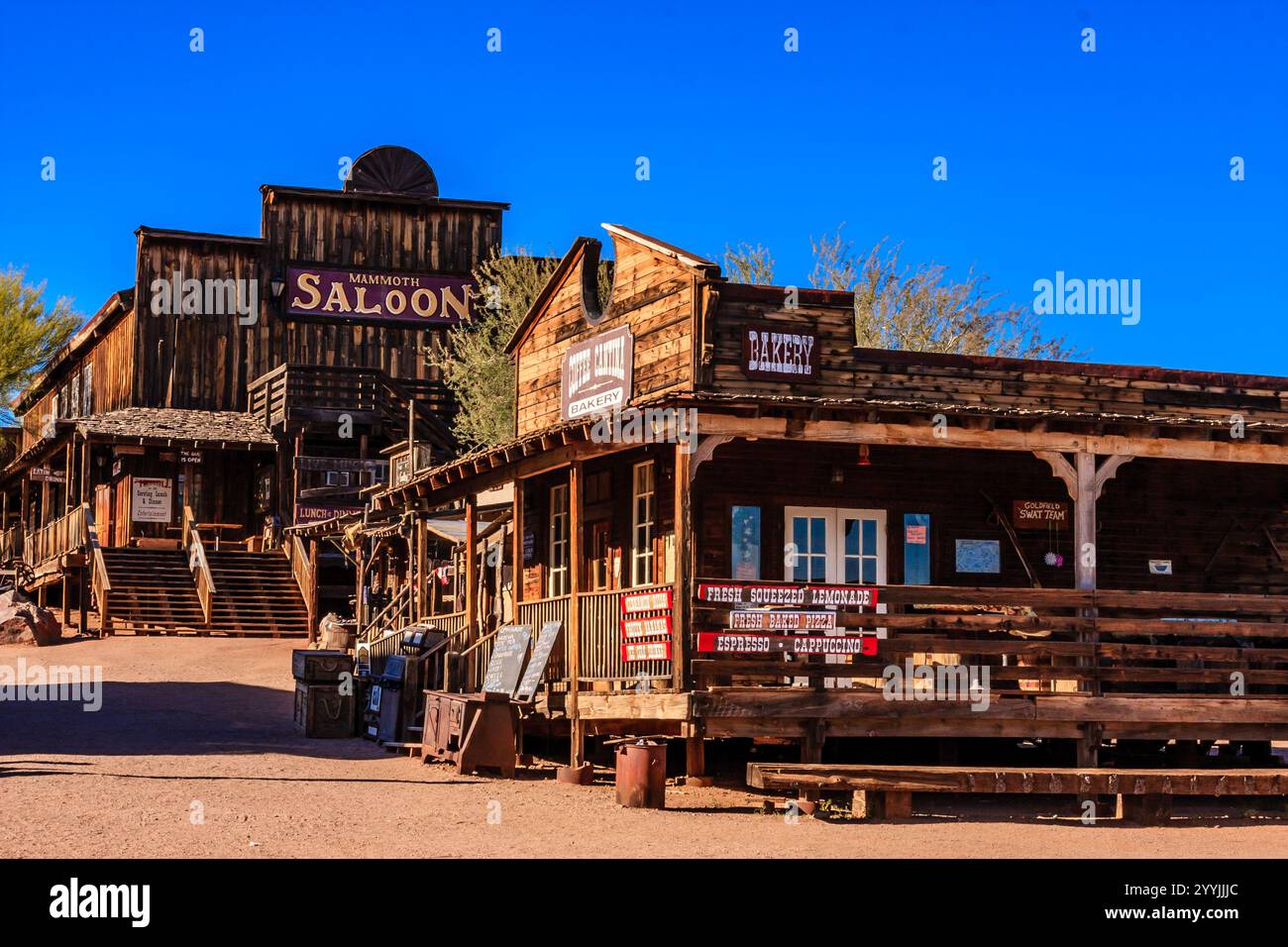 A small town with a saloon and a bar. The saloon is old and has a ...