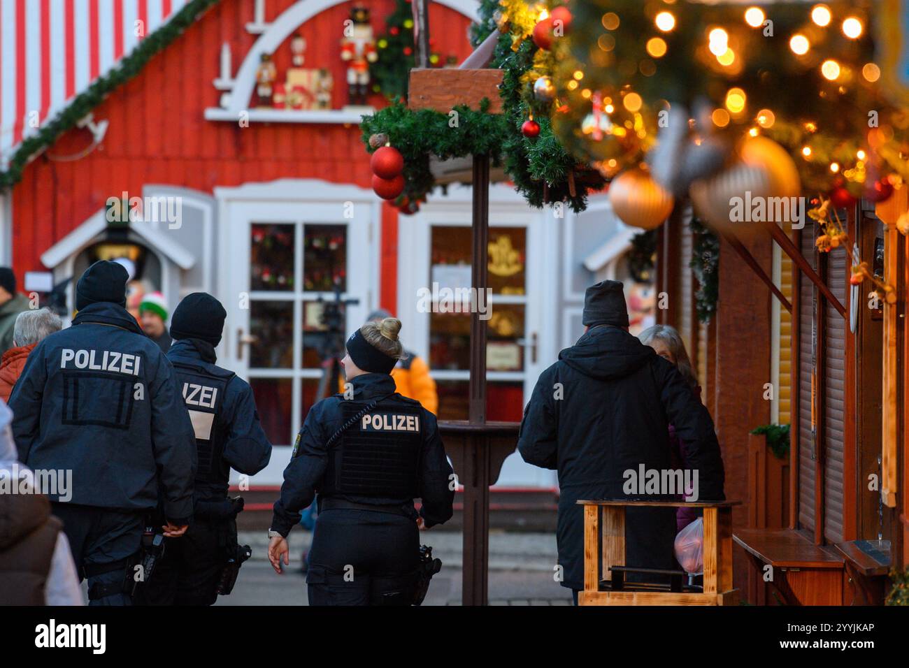 22 December 2024, Saxony-Anhalt, Magdeburg: Police officers and passers ...