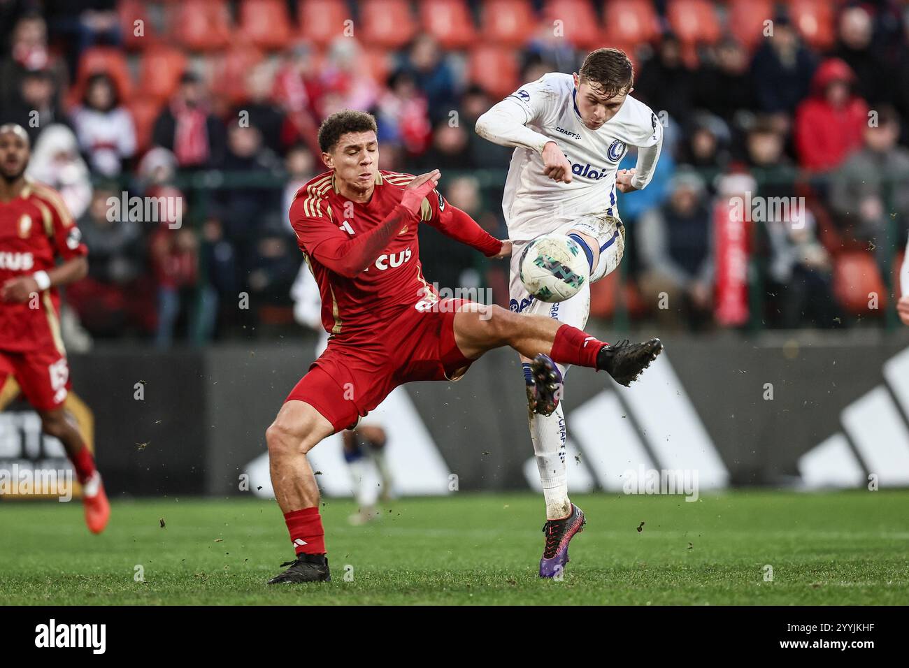 Standard's Lawrence Henry and Gent's Max Dean fight for the ball during ...