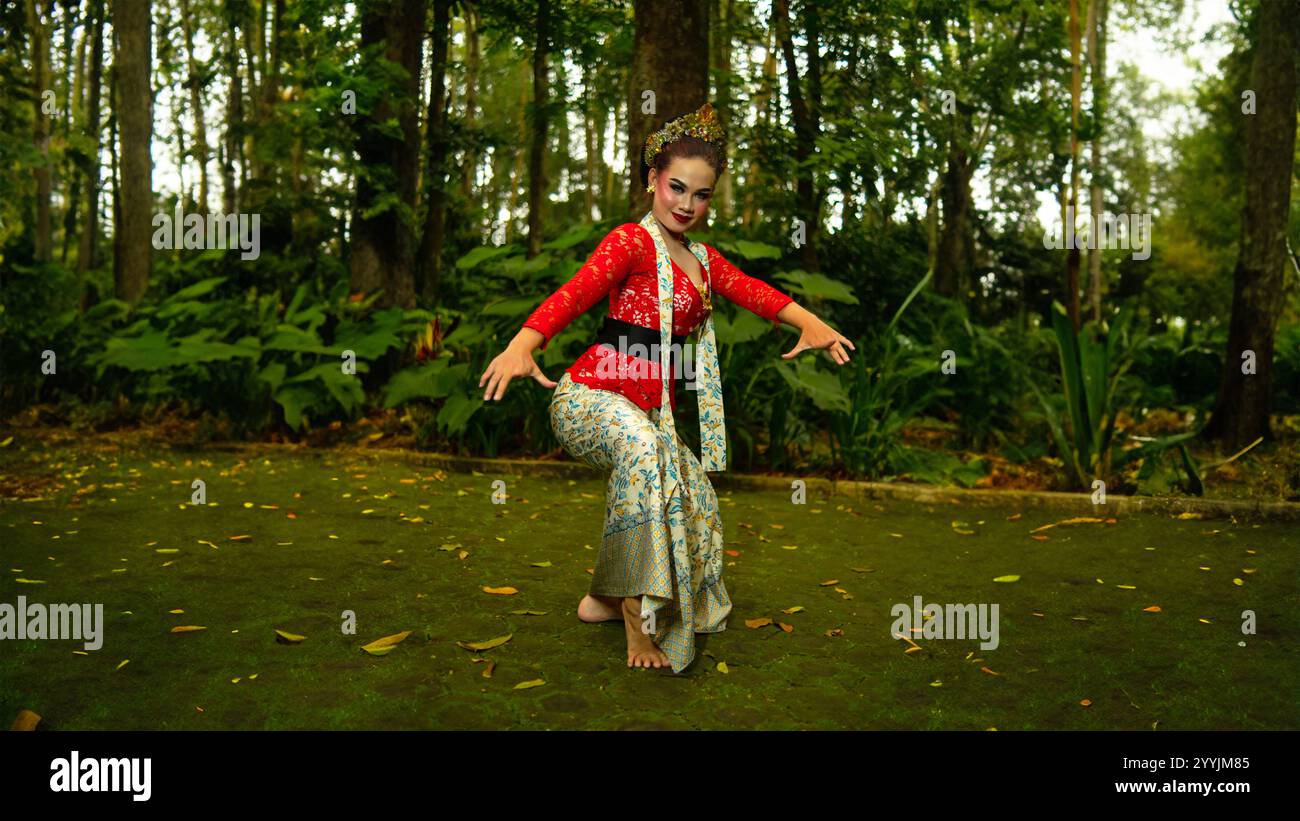 a traditional Sundanese dancer wearing a red costume that reflects the ...