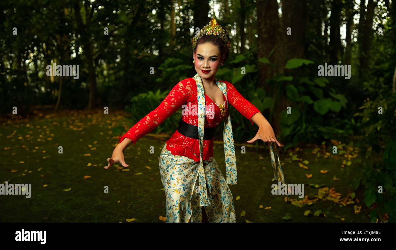 a traditional Sundanese dancer wearing a red costume that reflects the ...