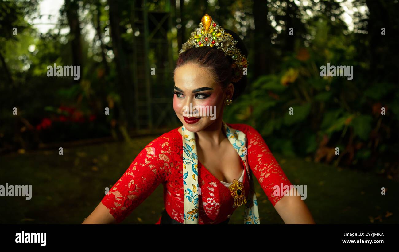 a traditional Sundanese dancer wearing a red costume that reflects the ...