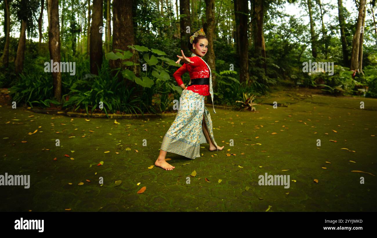 a traditional Sundanese dancer wearing a red costume that reflects the ...