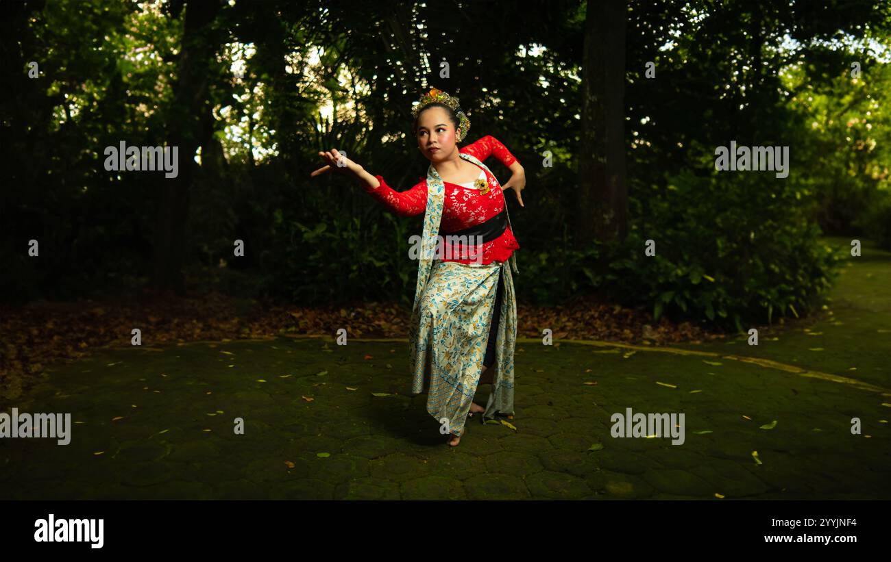 a Javanese dancer wearing a red costume that is thick with legends and ...