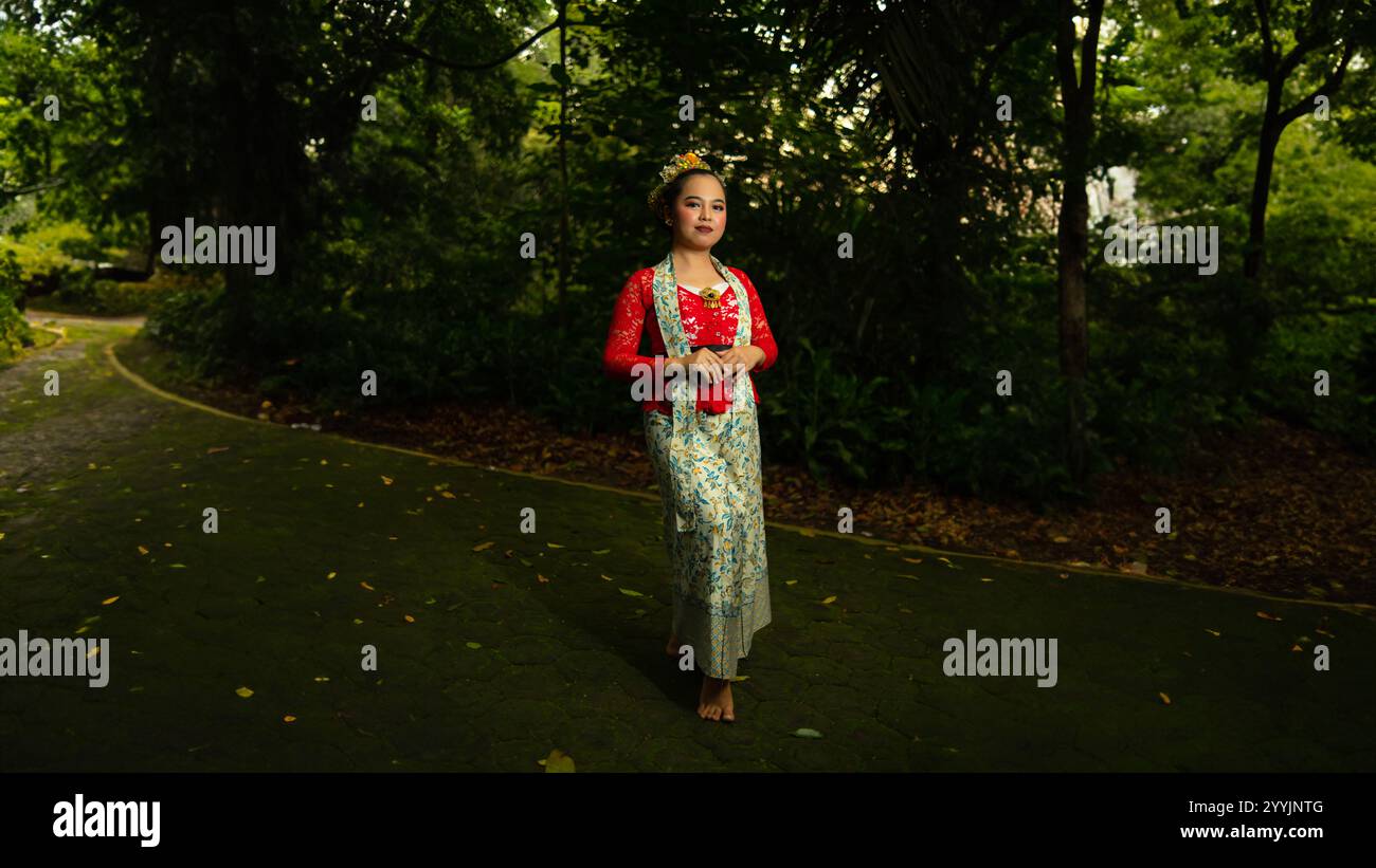 Traditional Javanese dancers wear red costumes that are full of details ...