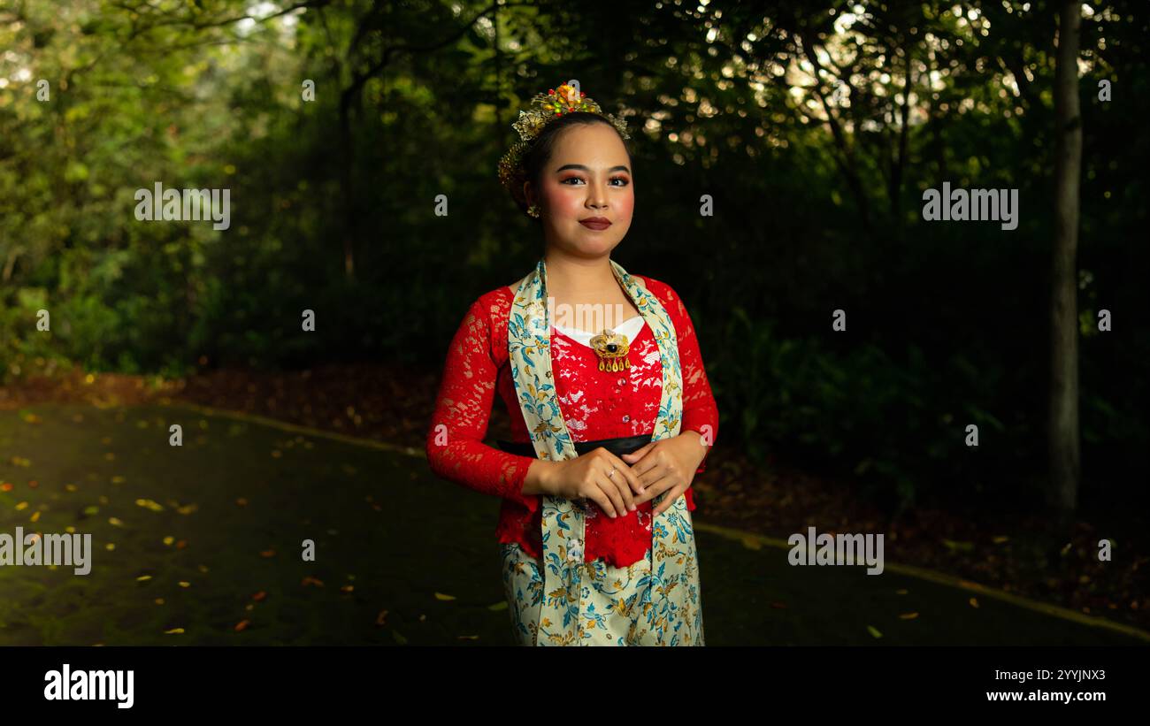 Traditional Javanese dancers wear red costumes that are full of details ...