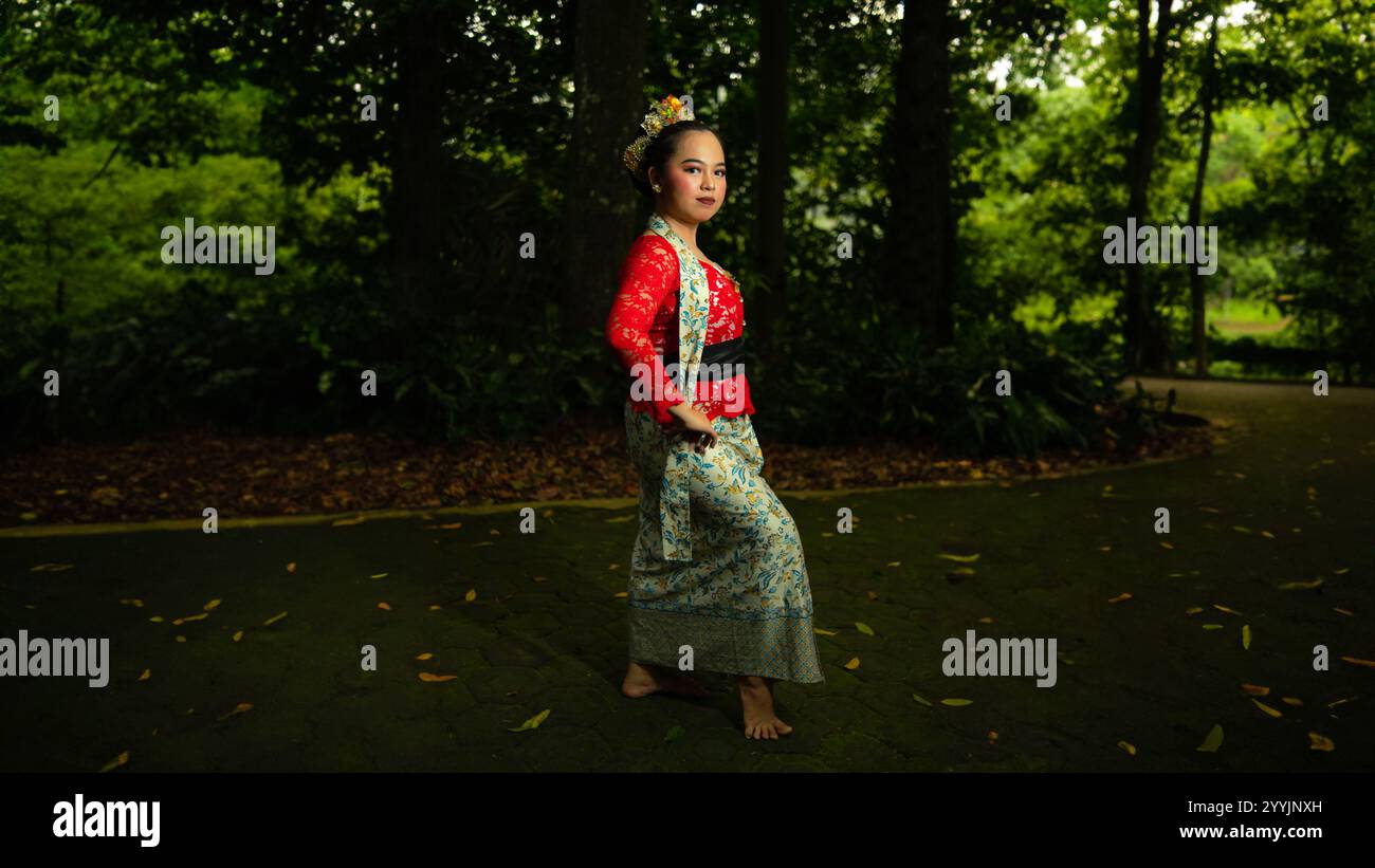 Traditional Javanese dancers wear red costumes that are full of details ...