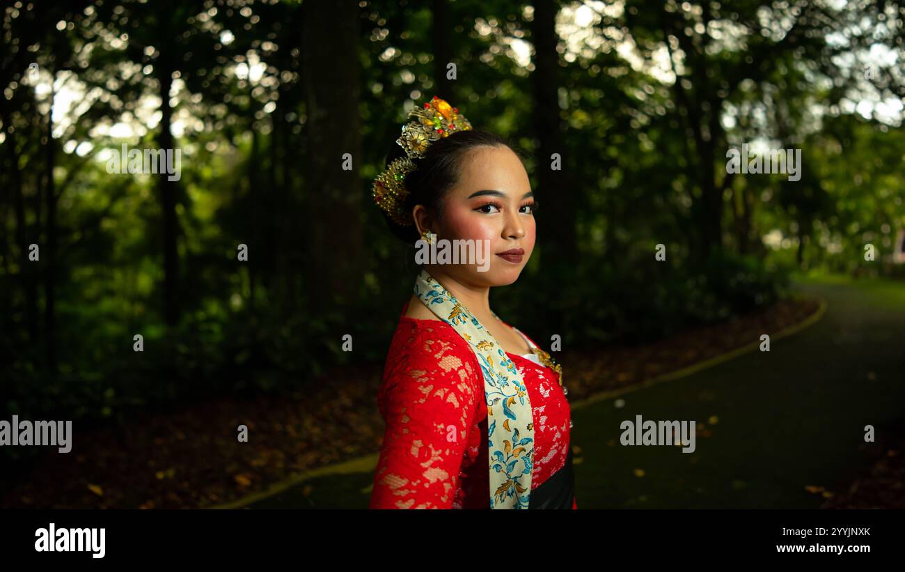 Traditional Javanese dancers wear red costumes that are full of details ...