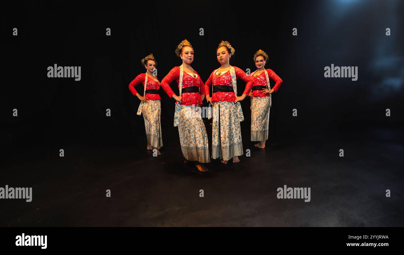 a group of female dancers in red costumes standing in a harmonious and ...