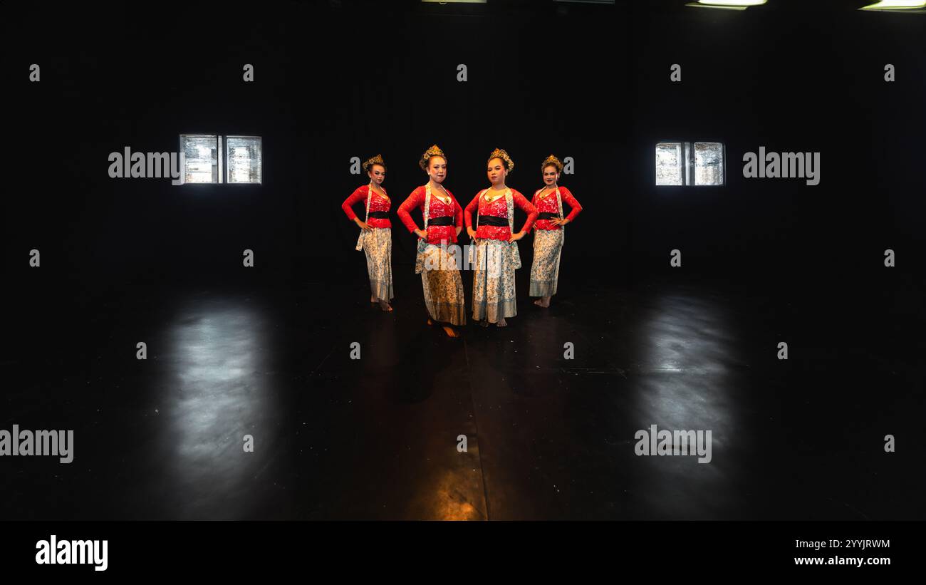 a group of female dancers in red costumes standing in a harmonious and ...