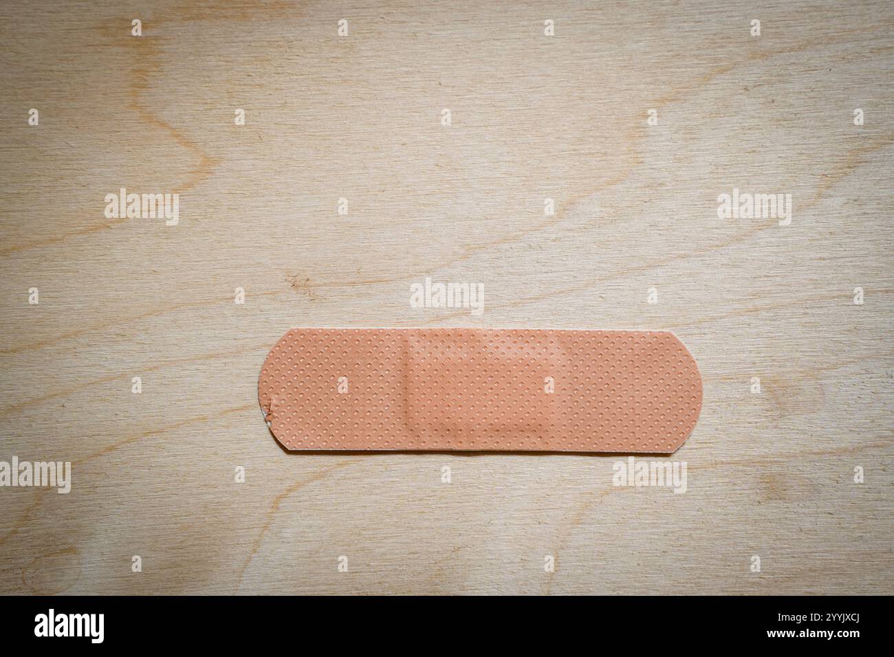 First aid adhedsive plaster isolated with text space on brown ...