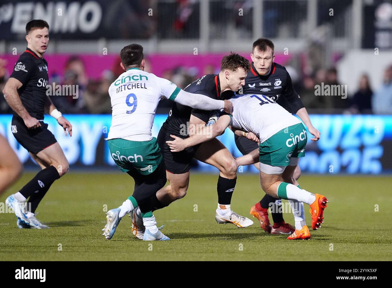Saracens' Tobias Elliott (centre) is tackled by Northampton Saints ...