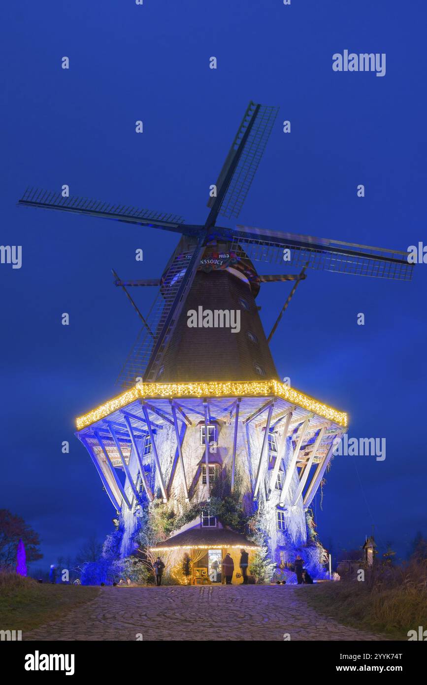 Illuminated windmill at night with blue and yellow light, world of ...